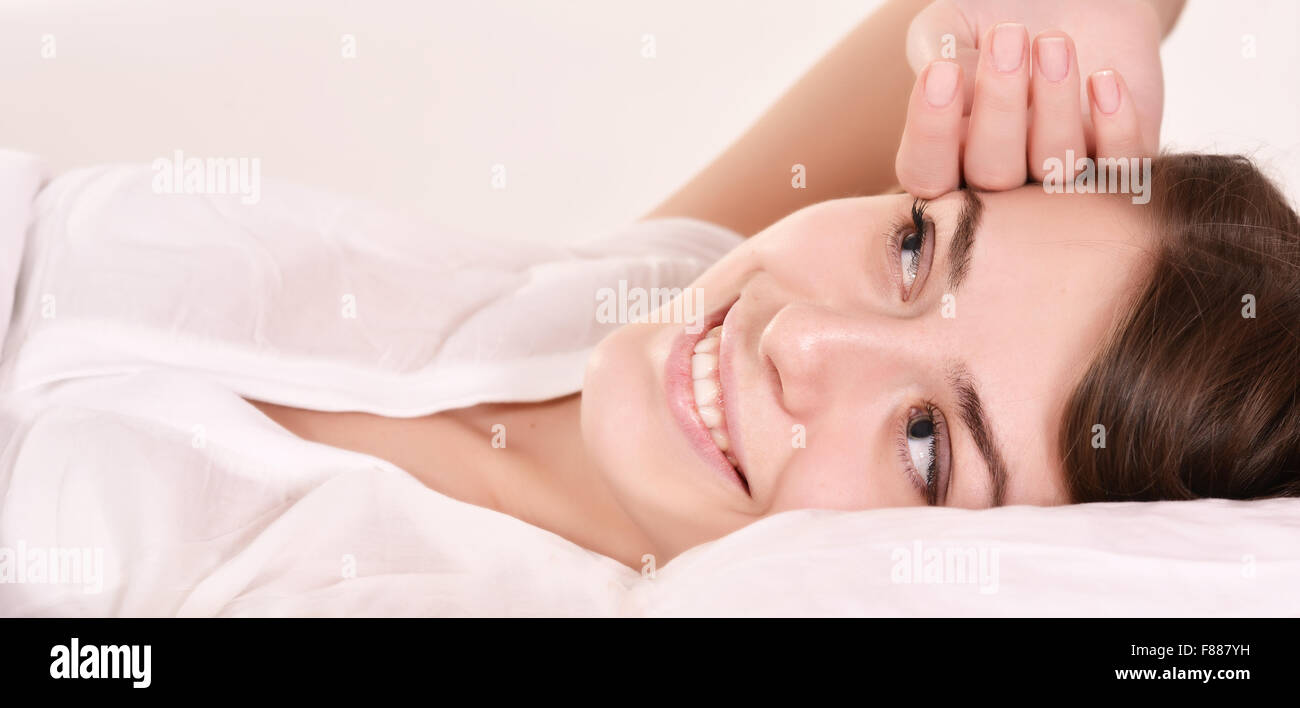 Young beautiful woman waking up Stock Photo - Alamy