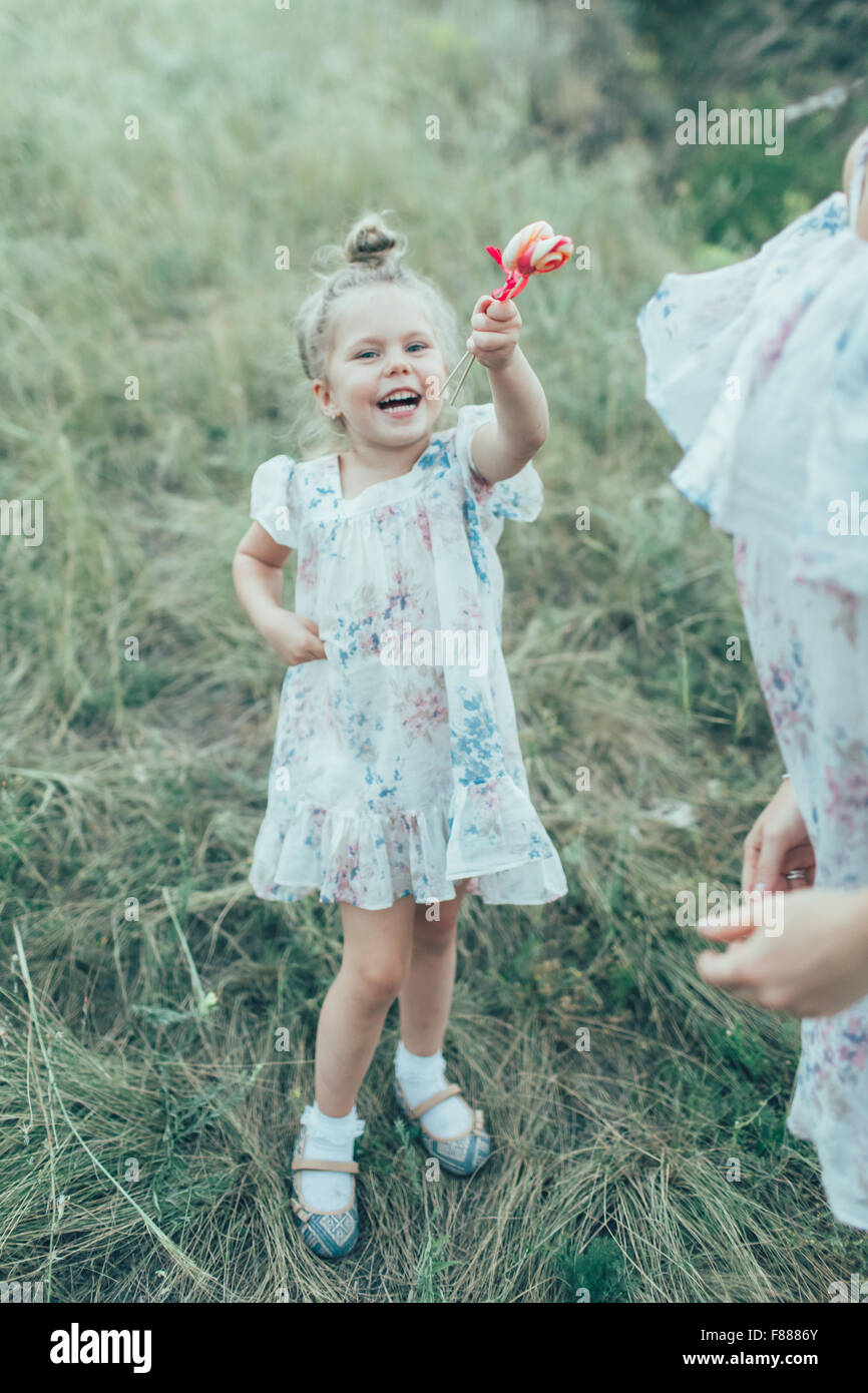 The young girl on green grass background Stock Photo - Alamy