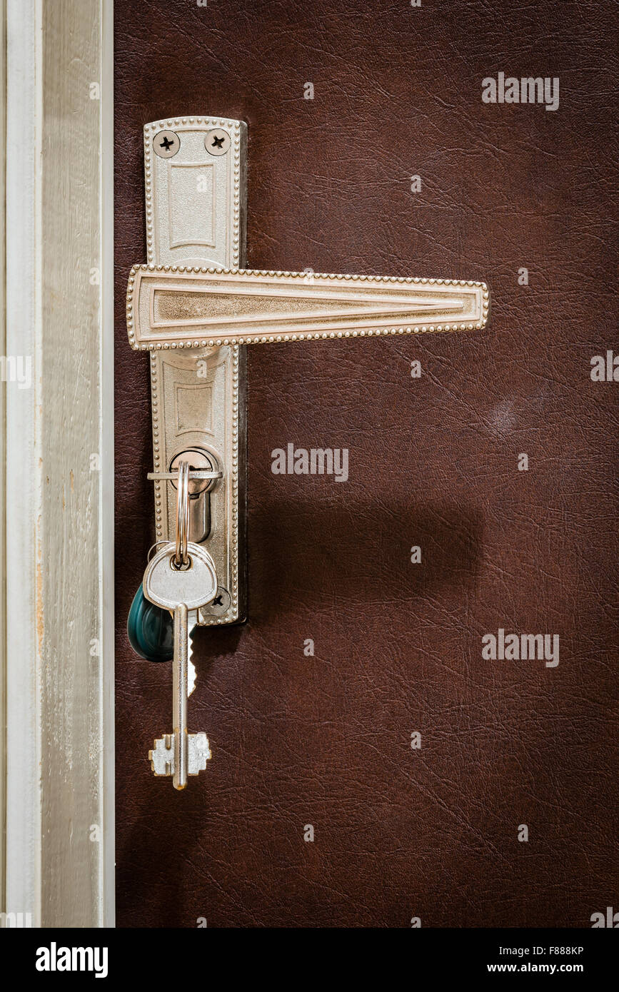 Home door. Keys are inserted in the lock of the entrance door of the ...