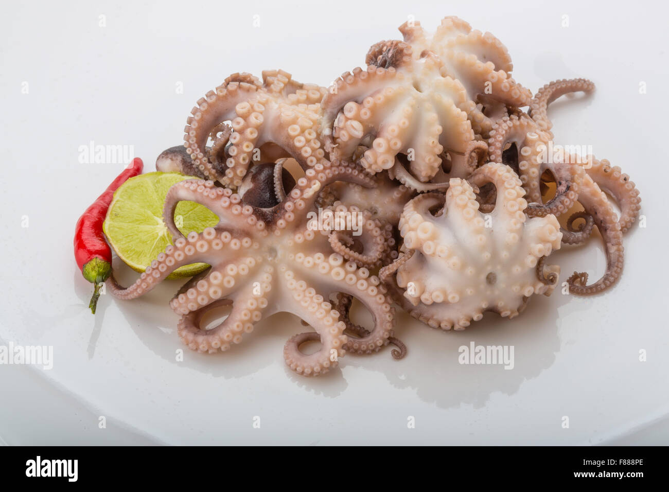 Boiled octopus with pepper and lime Stock Photo - Alamy