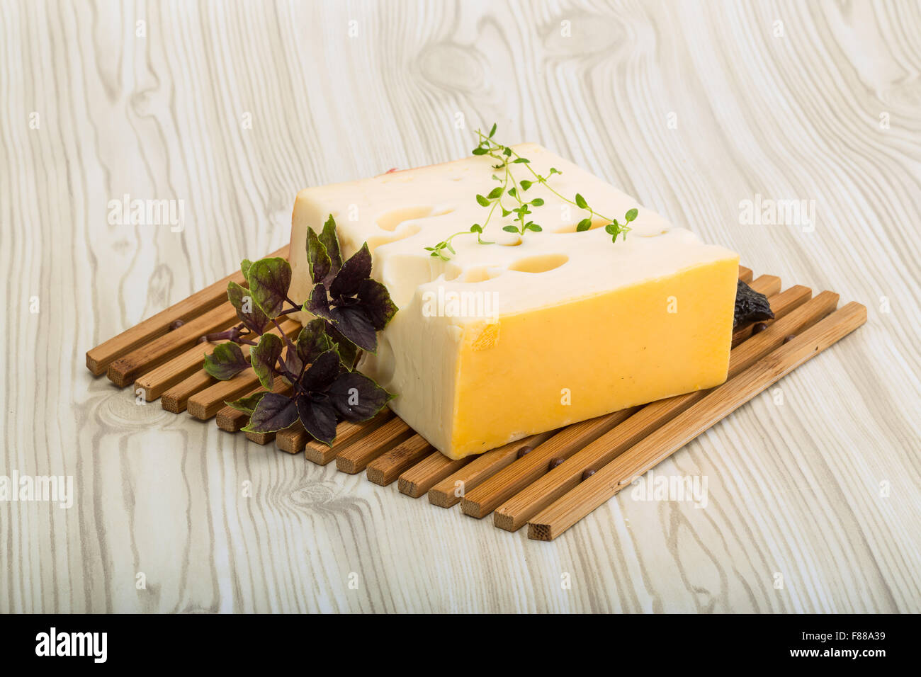 Yellow Cheese maasdam - with thyme and basil Stock Photo - Alamy