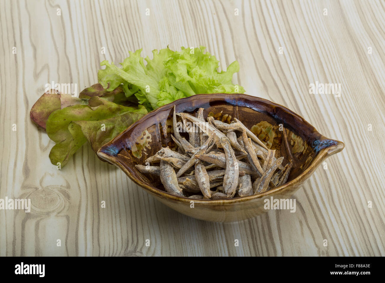 Dries anchovy - small fishes in the bowl Stock Photo - Alamy