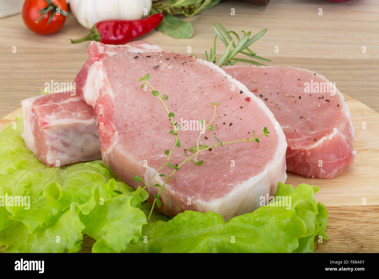 Raw pork steak - ready for cooking with herbs Stock Photo - Alamy