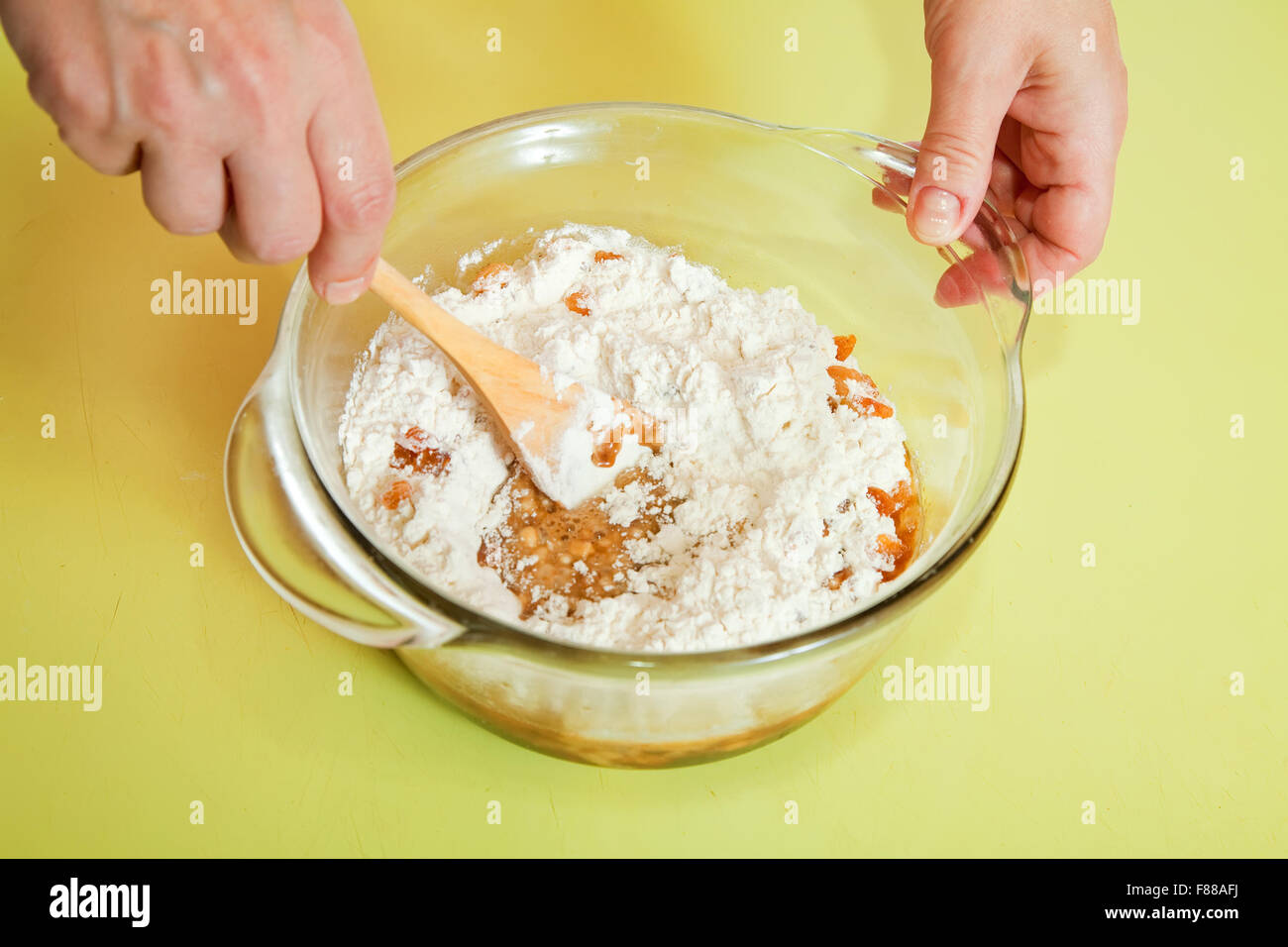 Closeup of woman making dough in dish. One of the stages of cooking of ...
