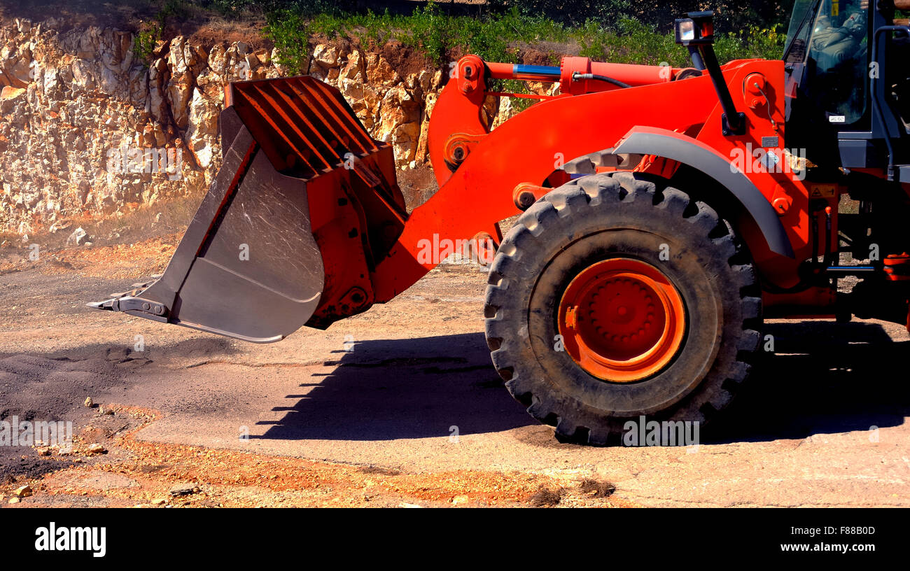 Bucket front of a big red wheeled loader Stock Photo - Alamy
