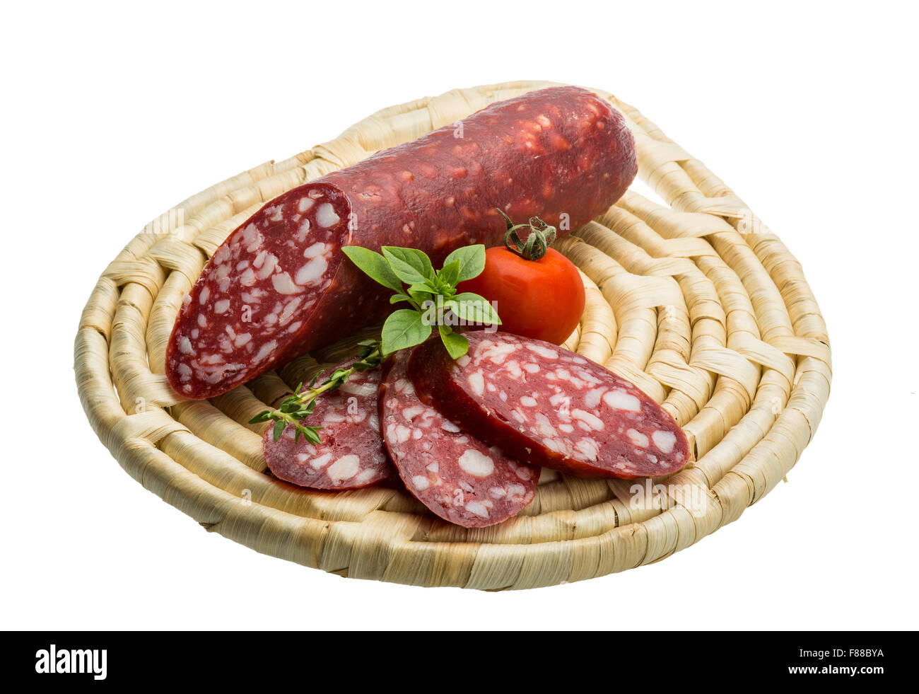 Salami sausages sliced with basil and tomato Stock Photo - Alamy
