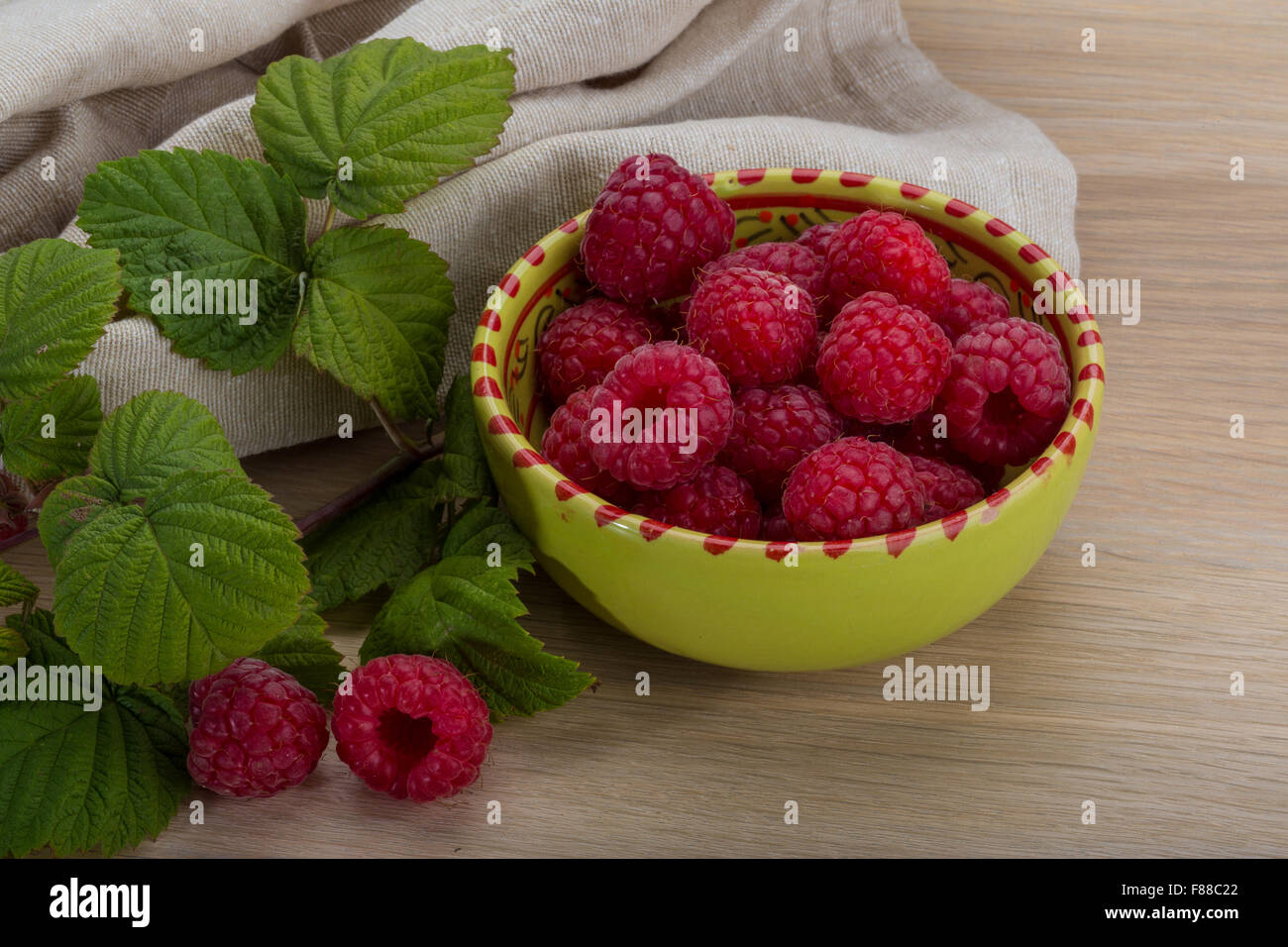 Fresh raspberry with leaf in the bowl Stock Photo - Alamy