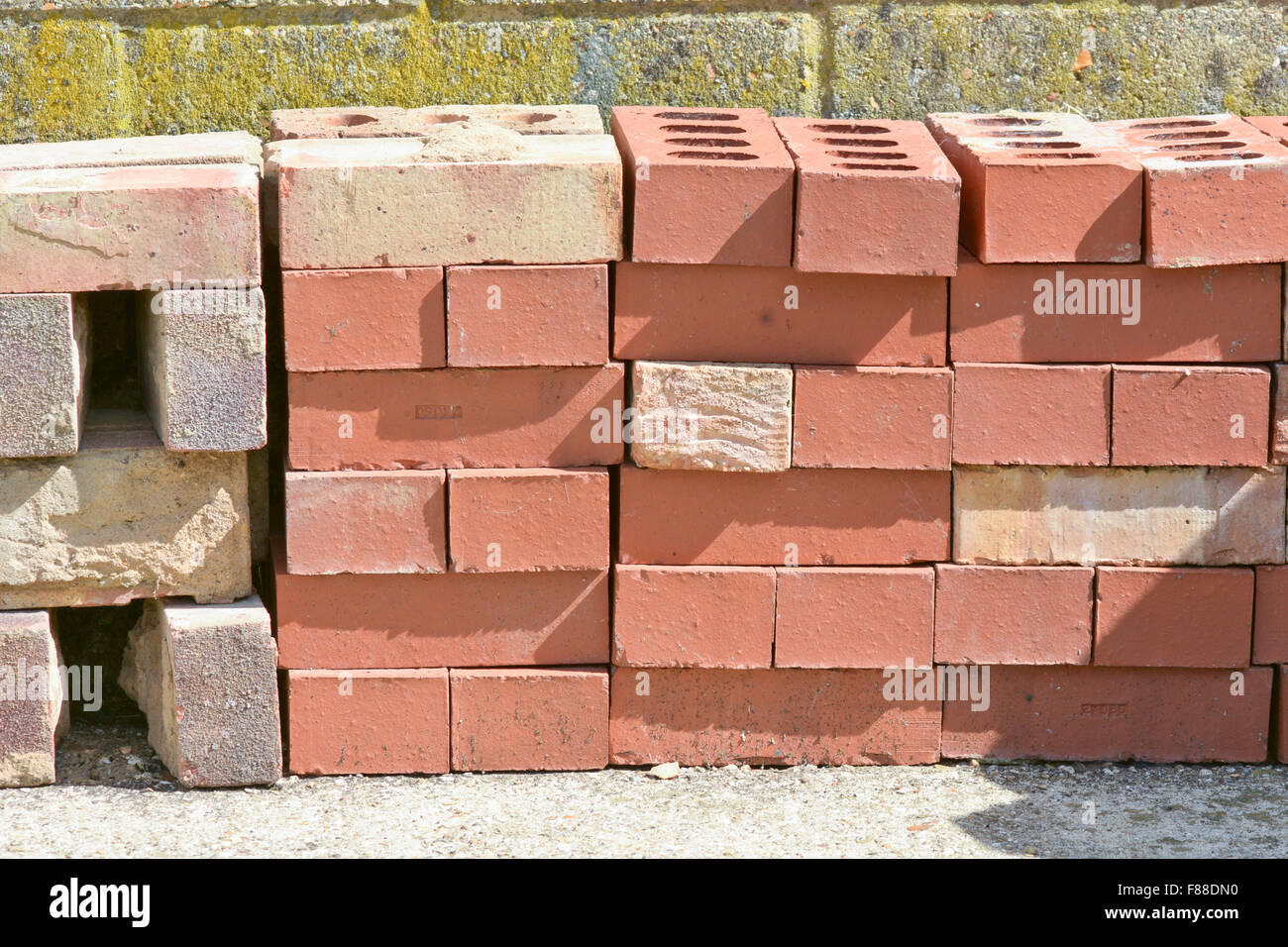 Stack of new and old red house bricks Stock Photo - Alamy