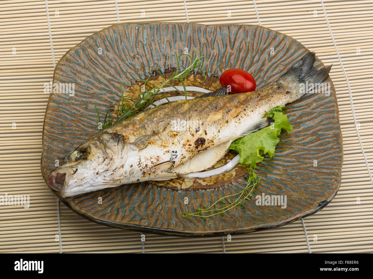 Grilled seabass fish - with rosemary and thyme Stock Photo - Alamy
