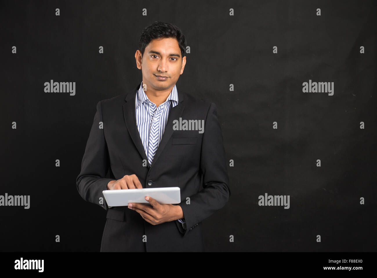 indian business male using tablet in black background Stock Photo - Alamy
