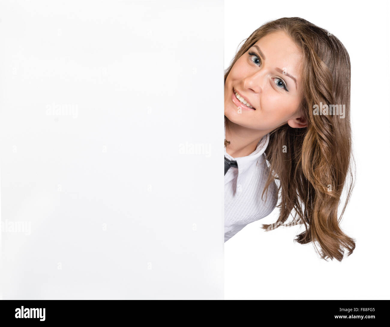 Girl looks out from behind an empty poster Stock Photo - Alamy