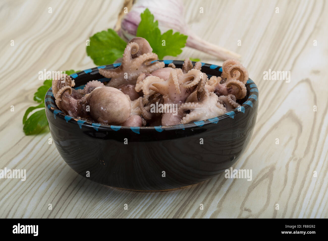 Boiled octopus - mini seafood in the bowl Stock Photo - Alamy