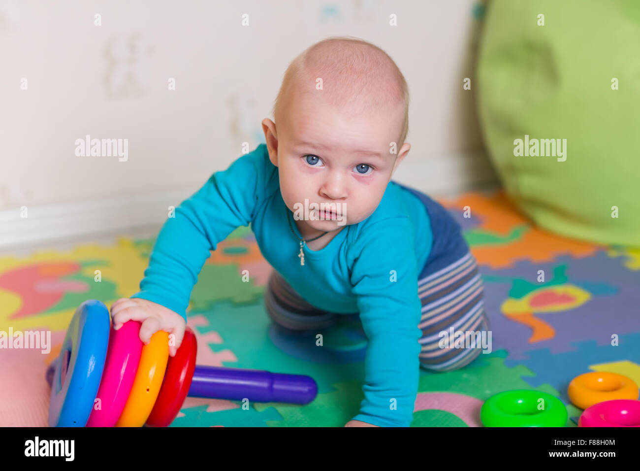 Cute little baby playing with colorful toys Stock Photo - Alamy