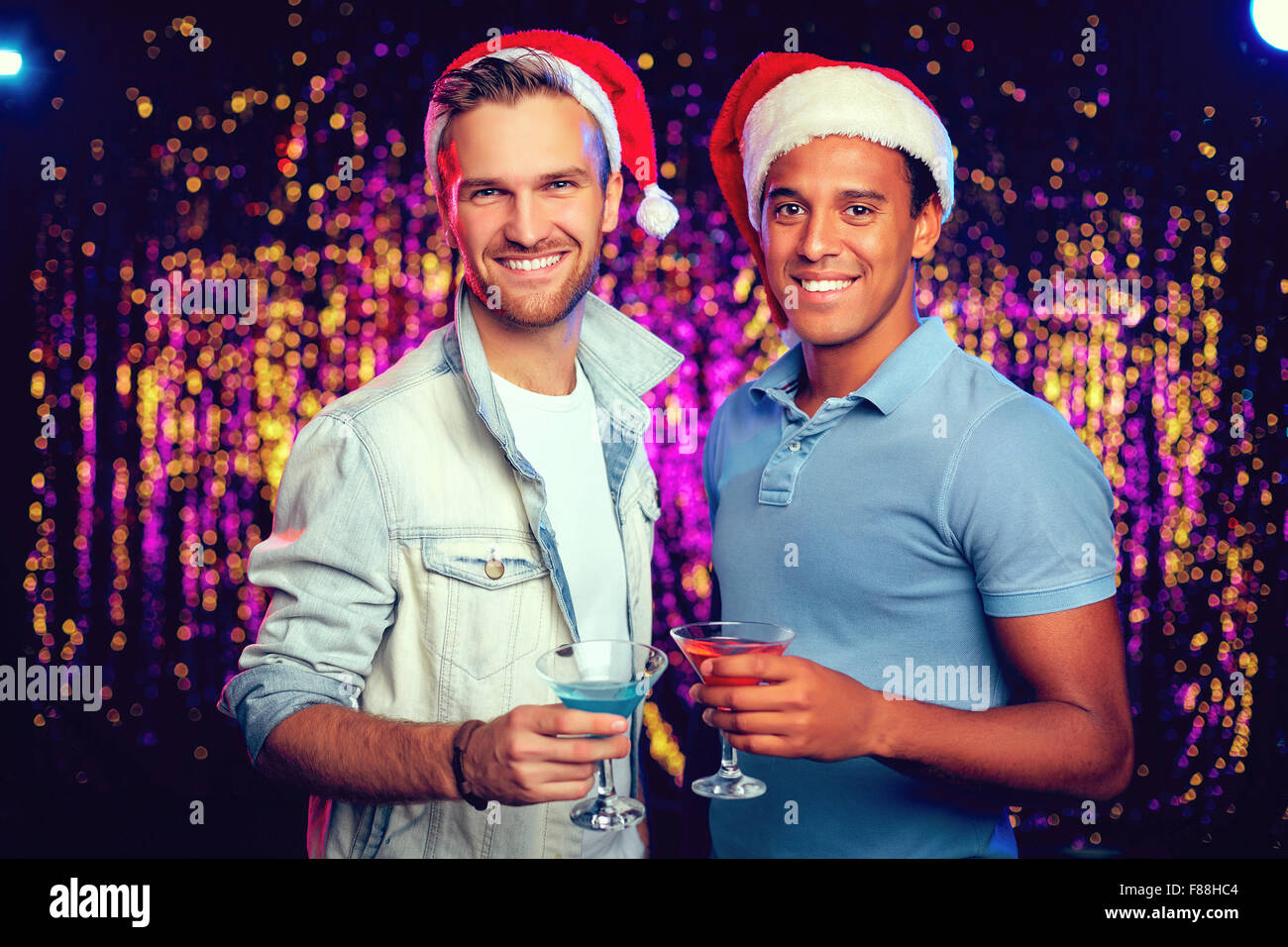Handsome Santa guys with drinks having party in night club Stock Photo ...