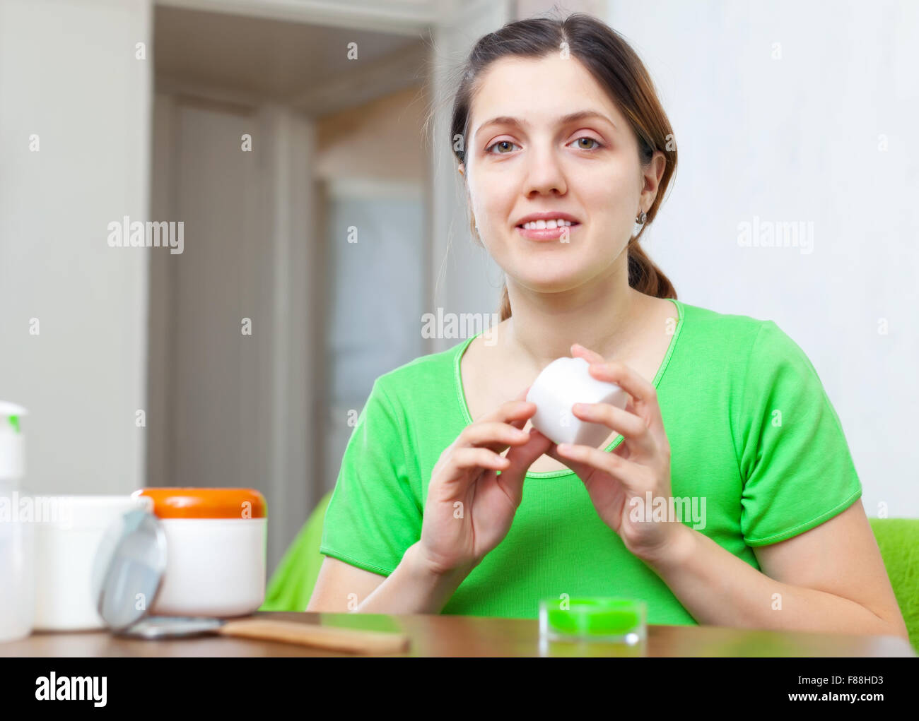 woman caring for face with cosmetics at home Stock Photo - Alamy