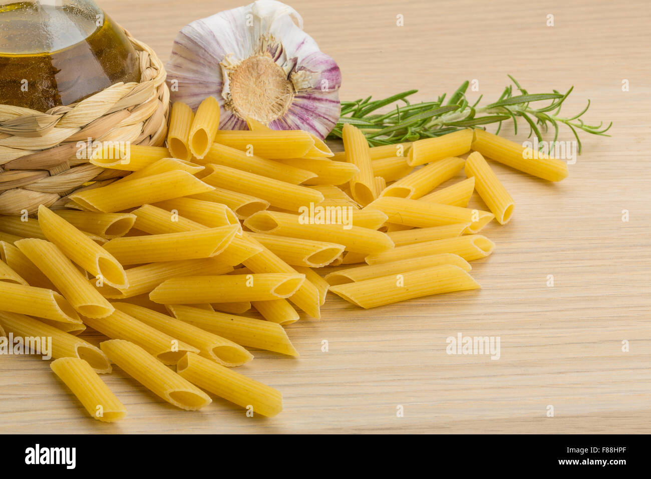 Penne - raw italian pasta with oil Stock Photo - Alamy