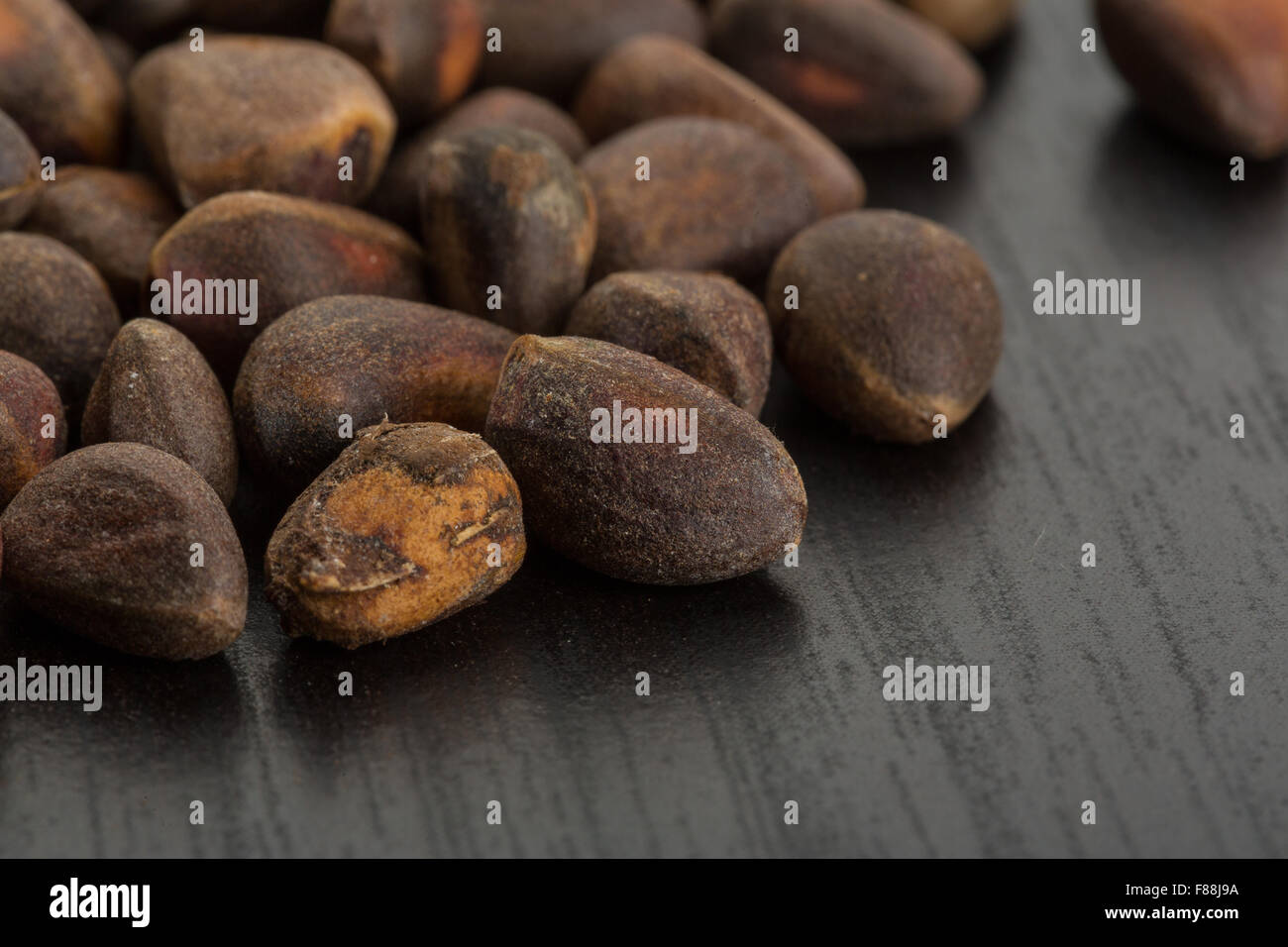 Cedar nuts on the desk Stock Photo - Alamy