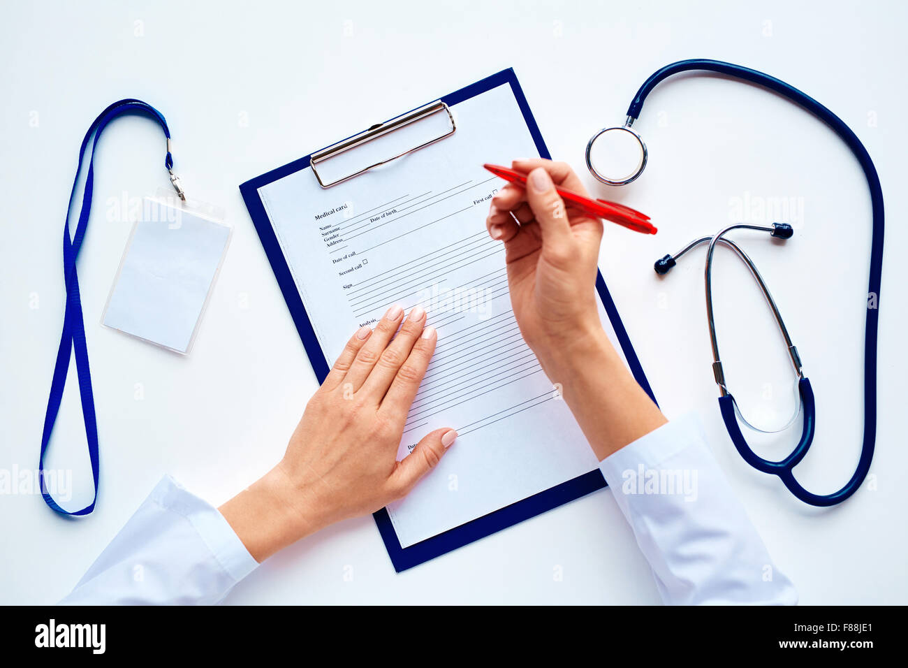 Human hands with pen filling in medical card Stock Photo - Alamy