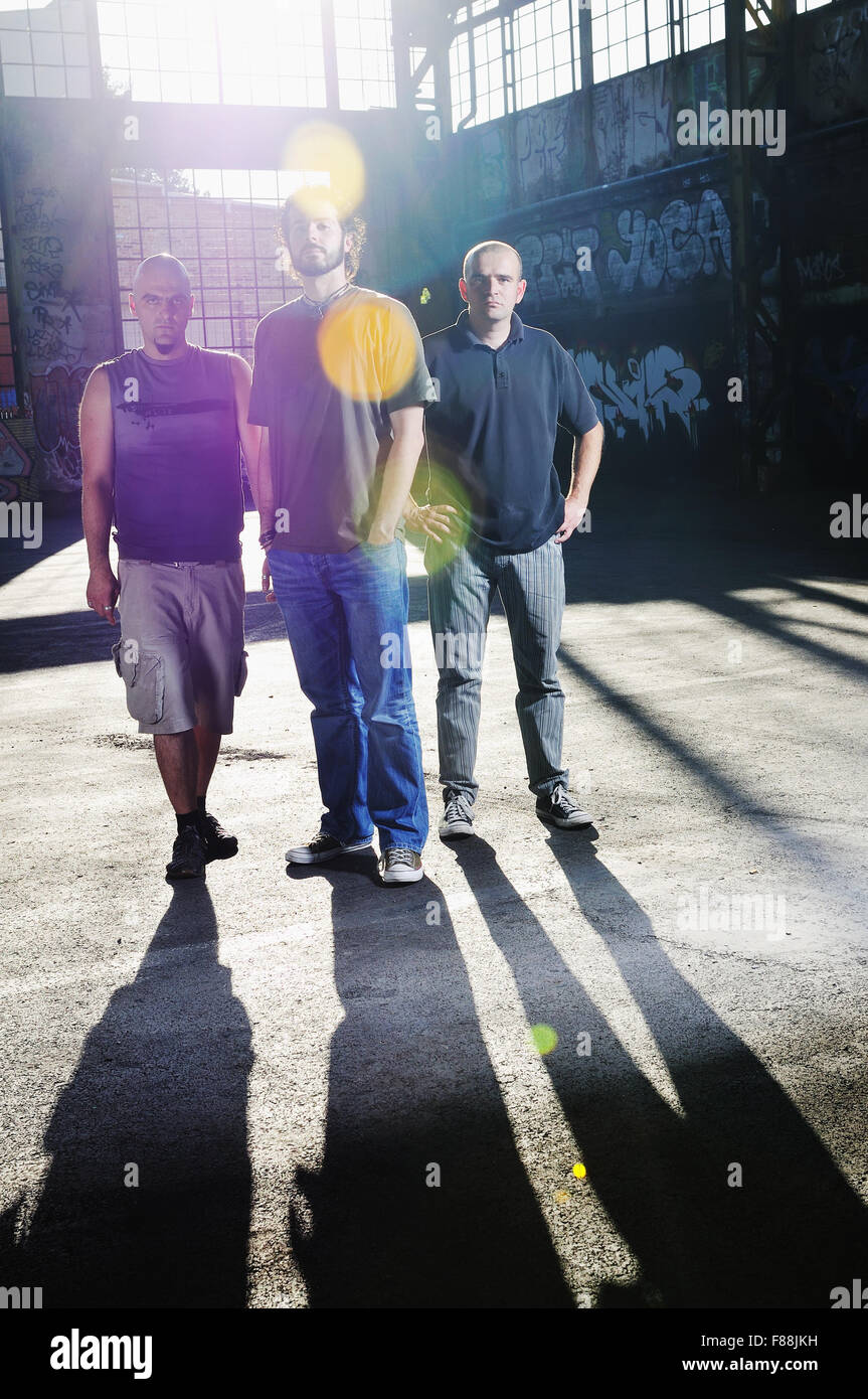 group of three adult man outdoor in the city at the sunset representing ...