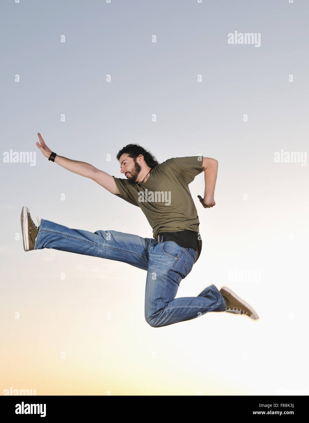 young man jumping in air at sunset outdoor Stock Photo - Alamy