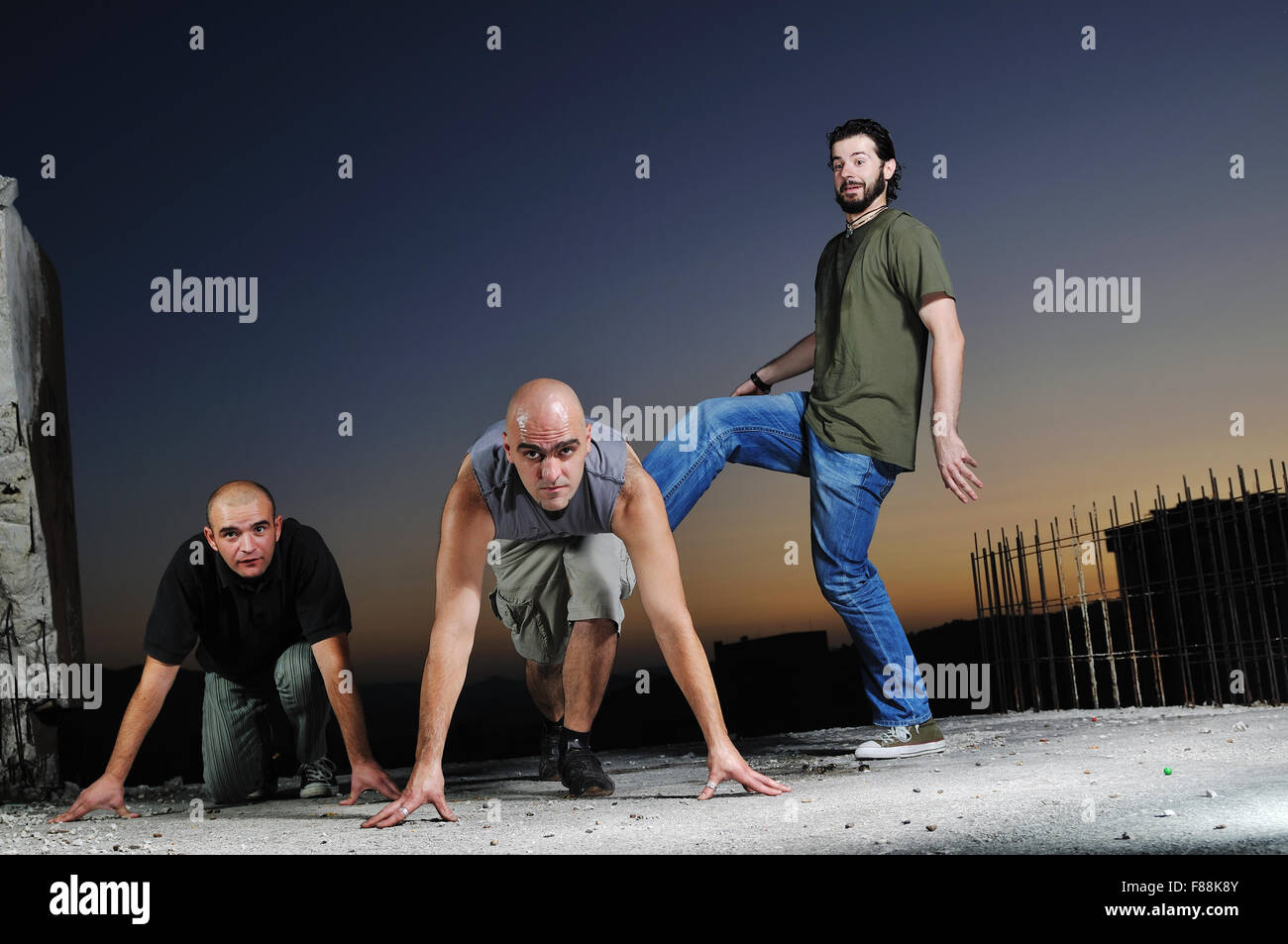 three young man in start position ready to race and run Stock Photo - Alamy
