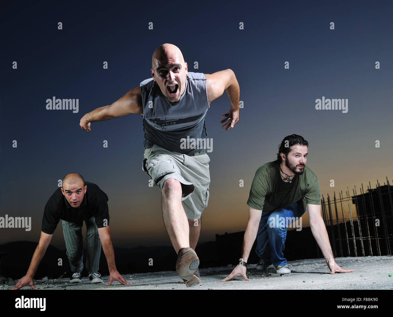 three young man in start position ready to race and run Stock Photo - Alamy