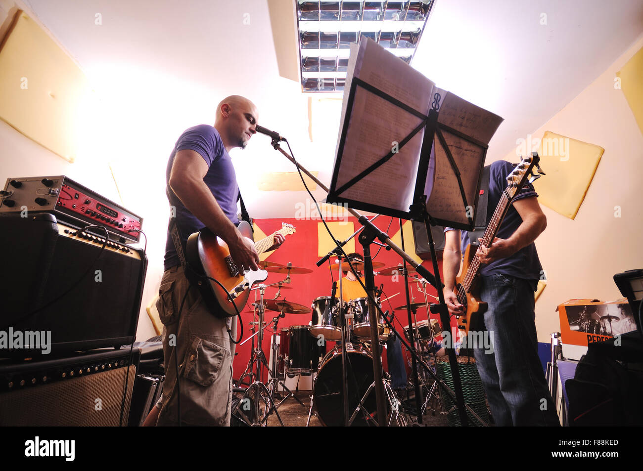 young music player and band friends have training in home garage Stock ...