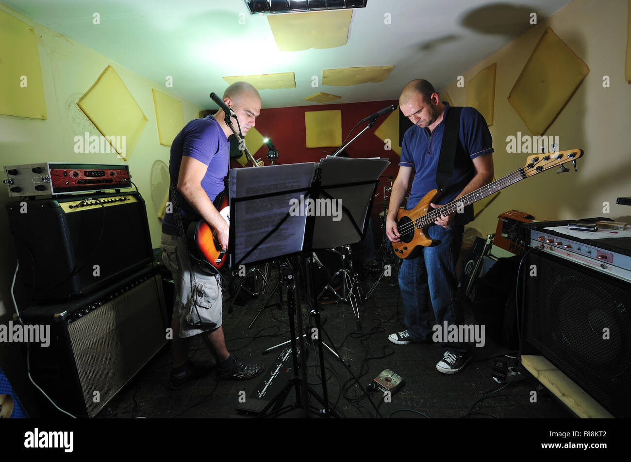 young music player and band friends have training in home garage Stock ...
