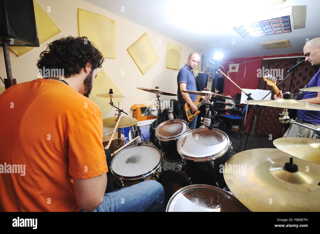 young music player and band friends have training in home garage Stock ...