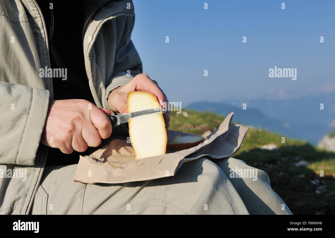 young happy, man slice fresh milk product cheese outdoor in nature ...