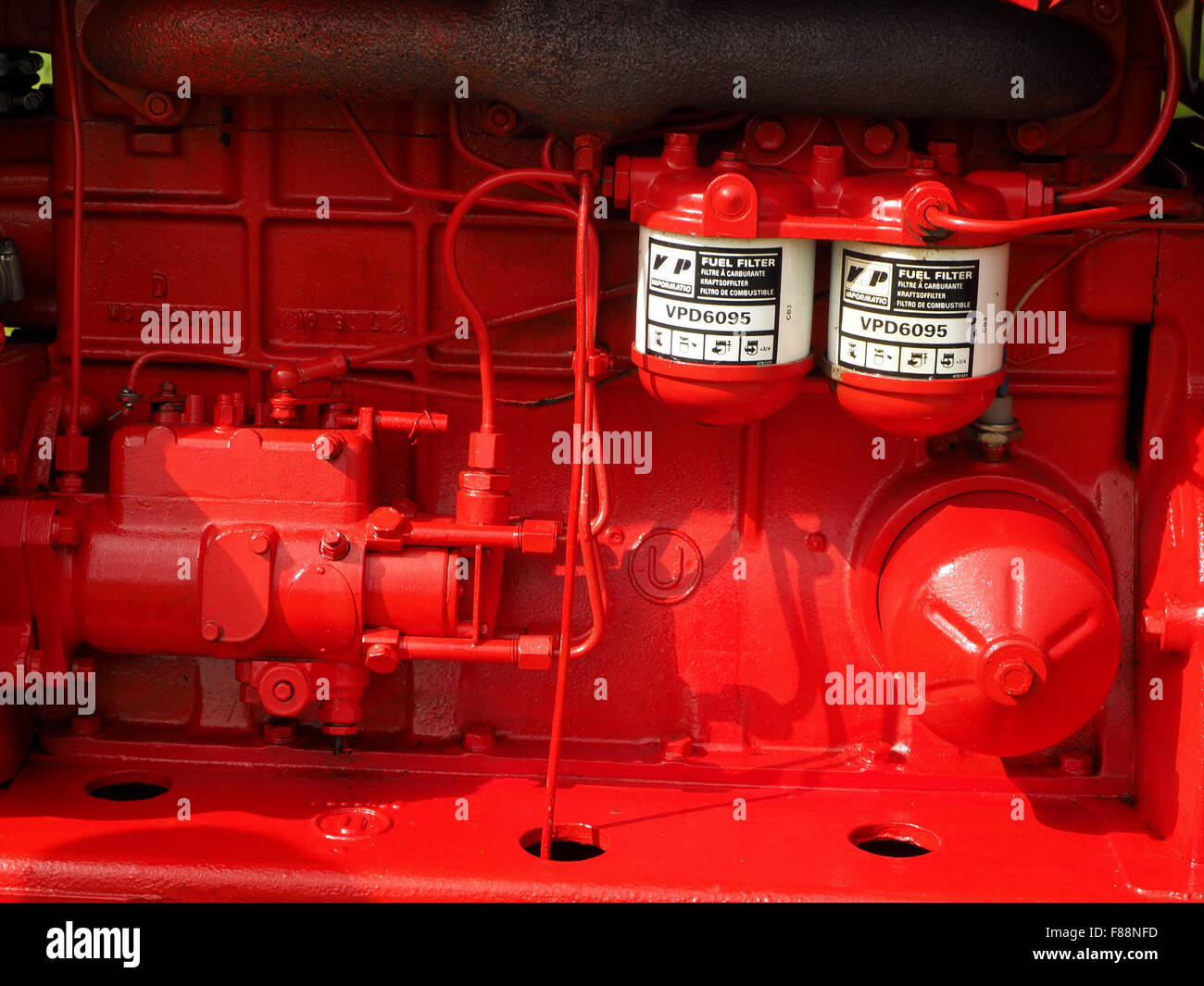 detail of painted engine of red tractor with pipework and cables Stock ...