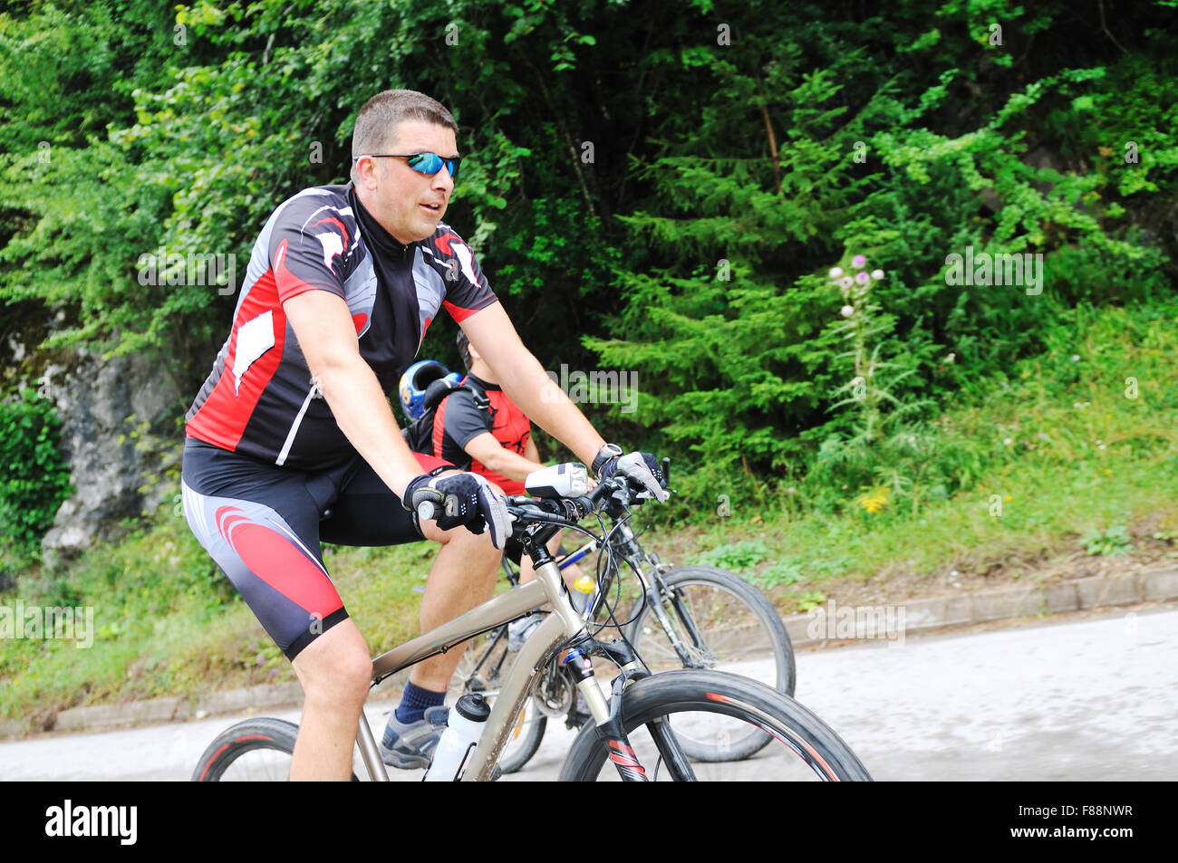 healthy lifestyle and fitness concept with mount bike man who ride bike ...