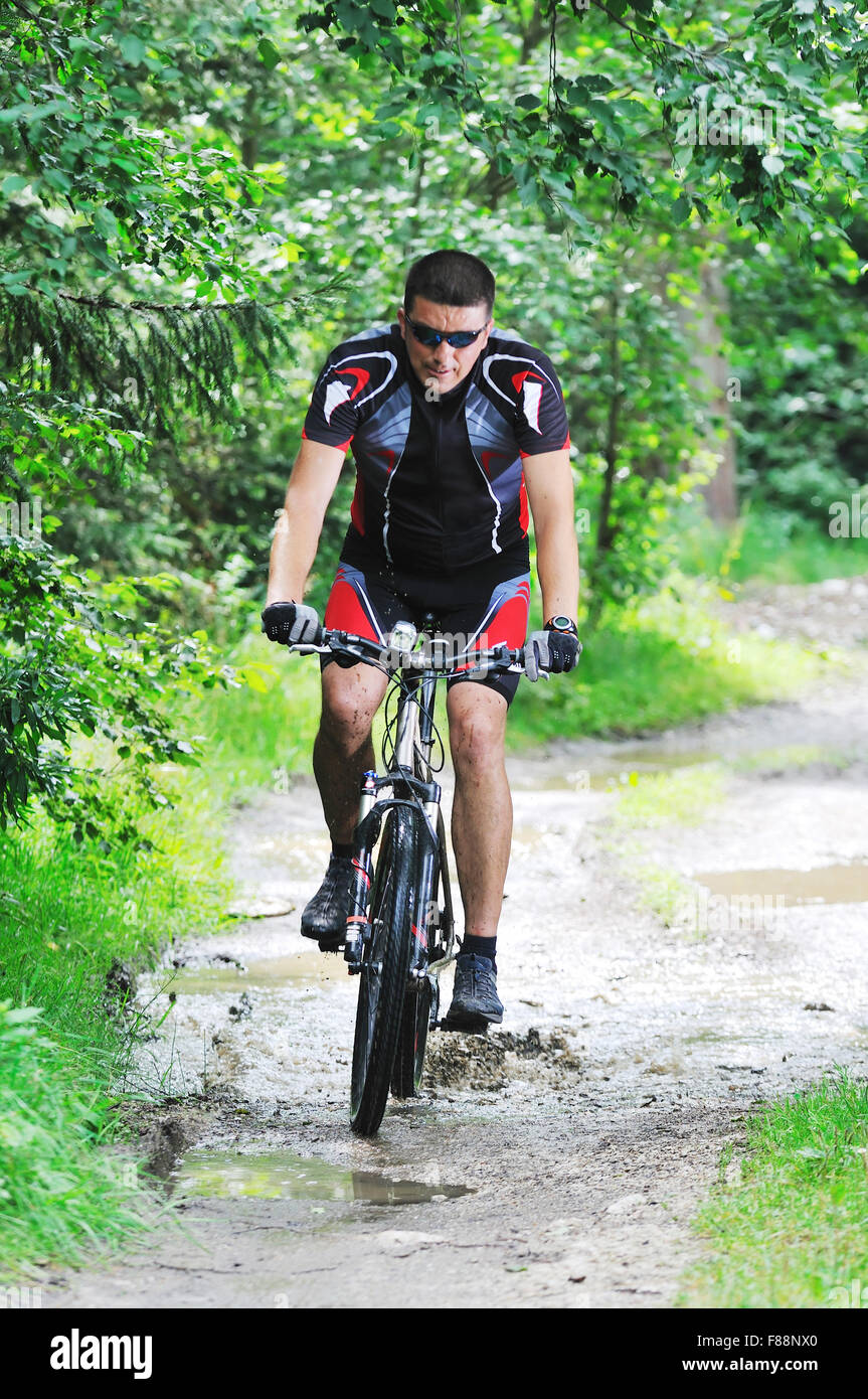 healthy lifestyle and fitness concept with mount bike man who ride bike ...