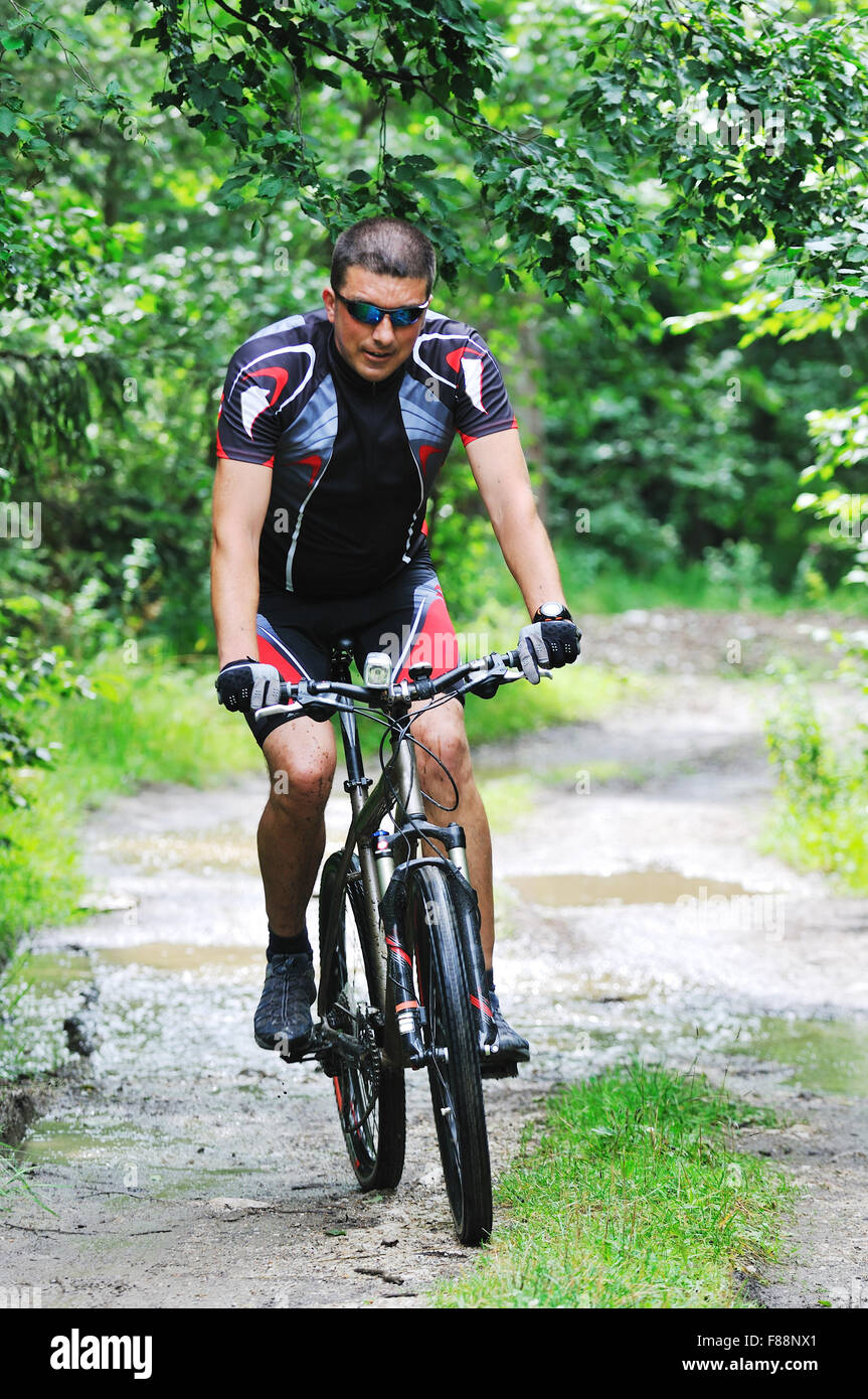 healthy lifestyle and fitness concept with mount bike man who ride bike ...