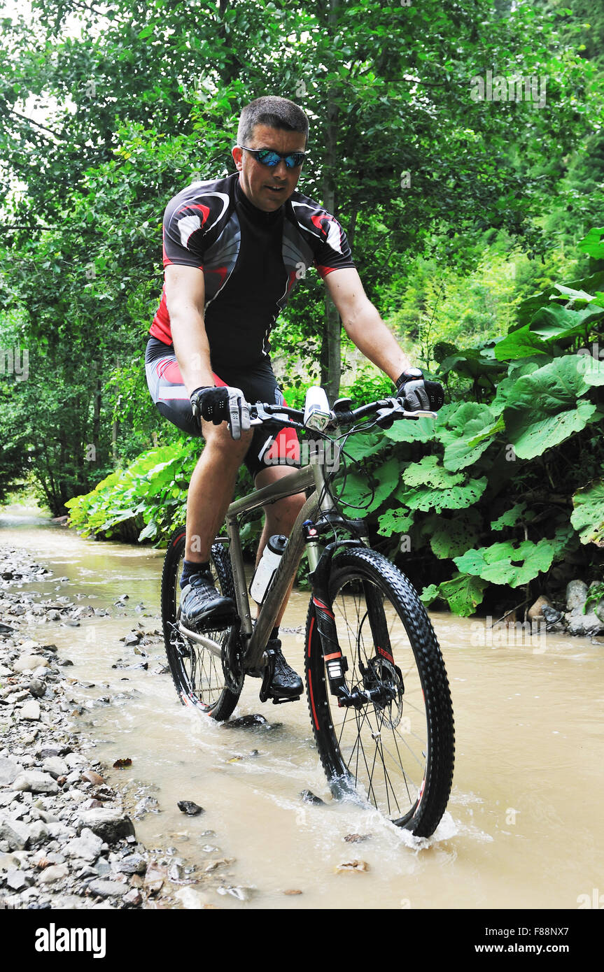 healthy lifestyle and fitness concept with mount bike man who ride bike ...