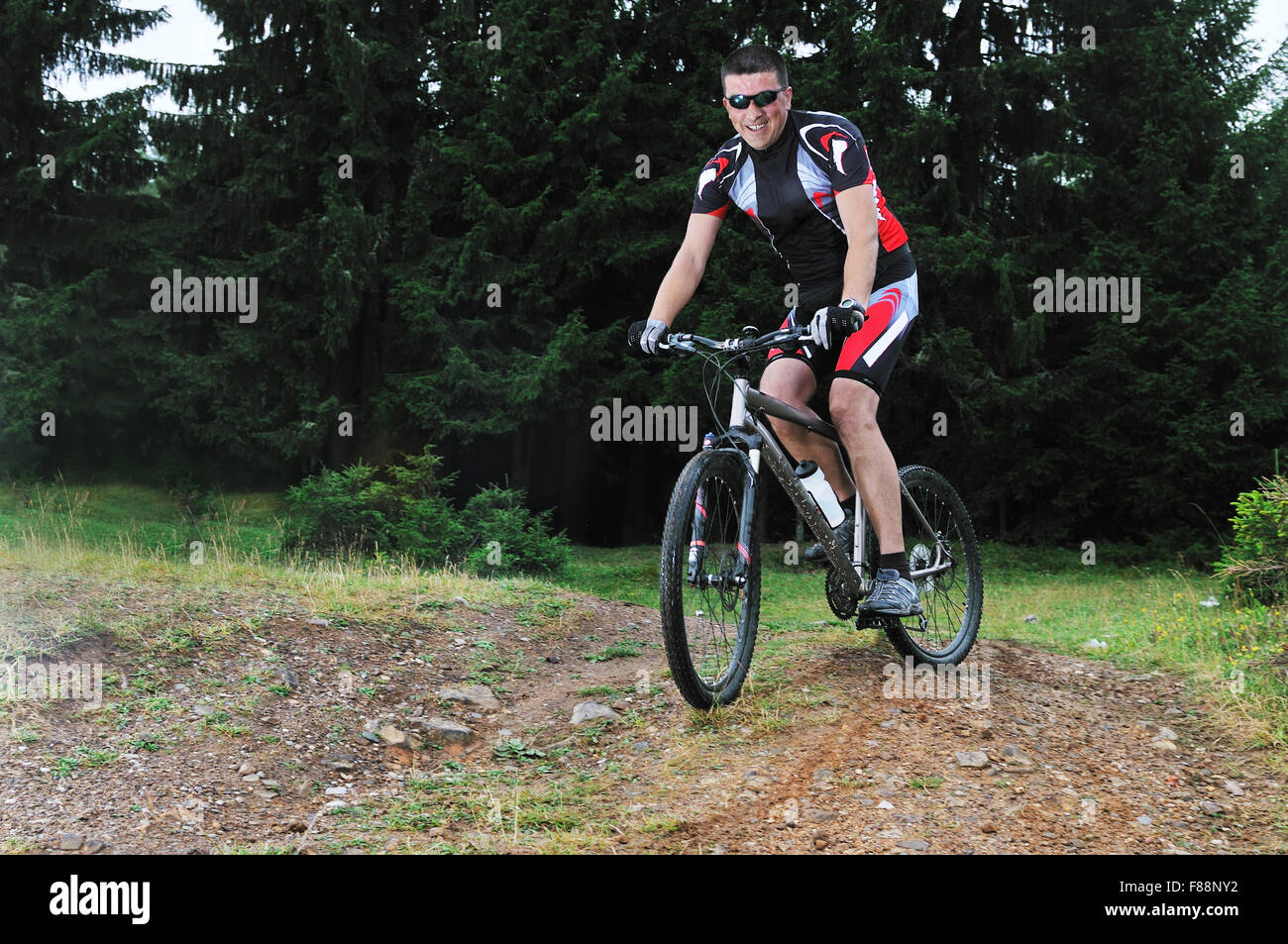 healthy lifestyle and fitness concept with mount bike man who ride bike ...