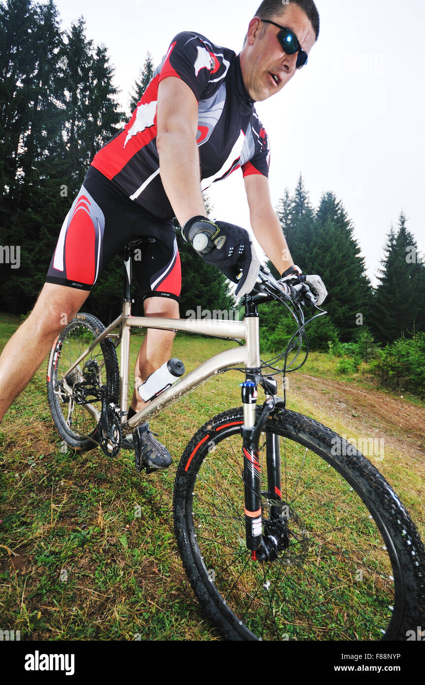 healthy lifestyle and fitness concept with mount bike man who ride bike ...