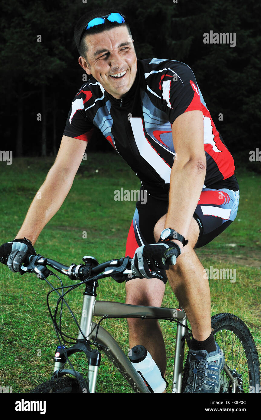 healthy lifestyle and fitness concept with mount bike man who ride bike ...