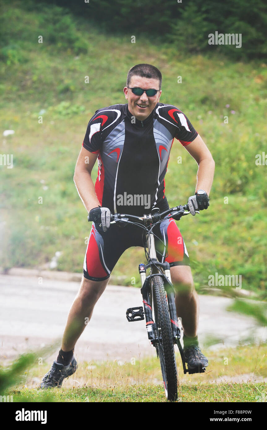 healthy lifestyle and fitness concept with mount bike man who ride bike ...