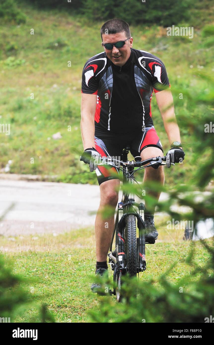 healthy lifestyle and fitness concept with mount bike man who ride bike ...