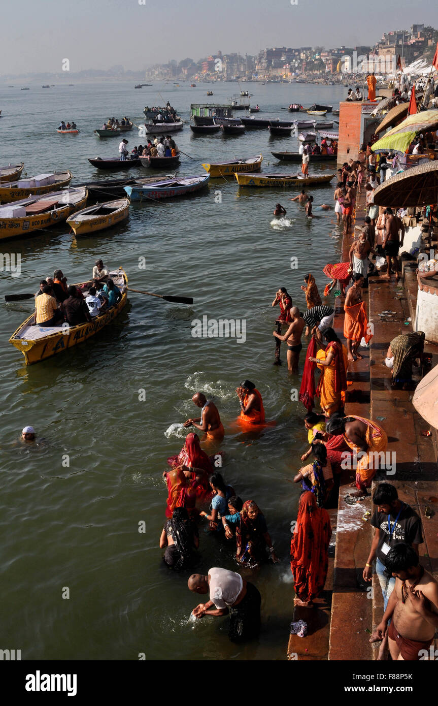 Hindu devotees praying in knee deep ganga water at Ghat in Varanasi ...