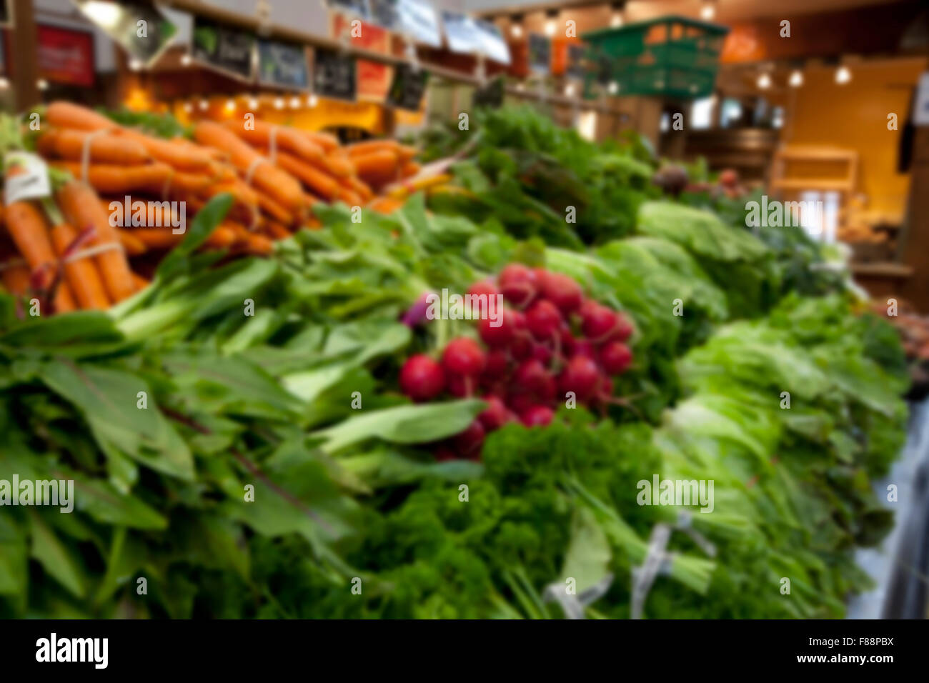 vegetable stand in supermarket blurred Stock Photo - Alamy