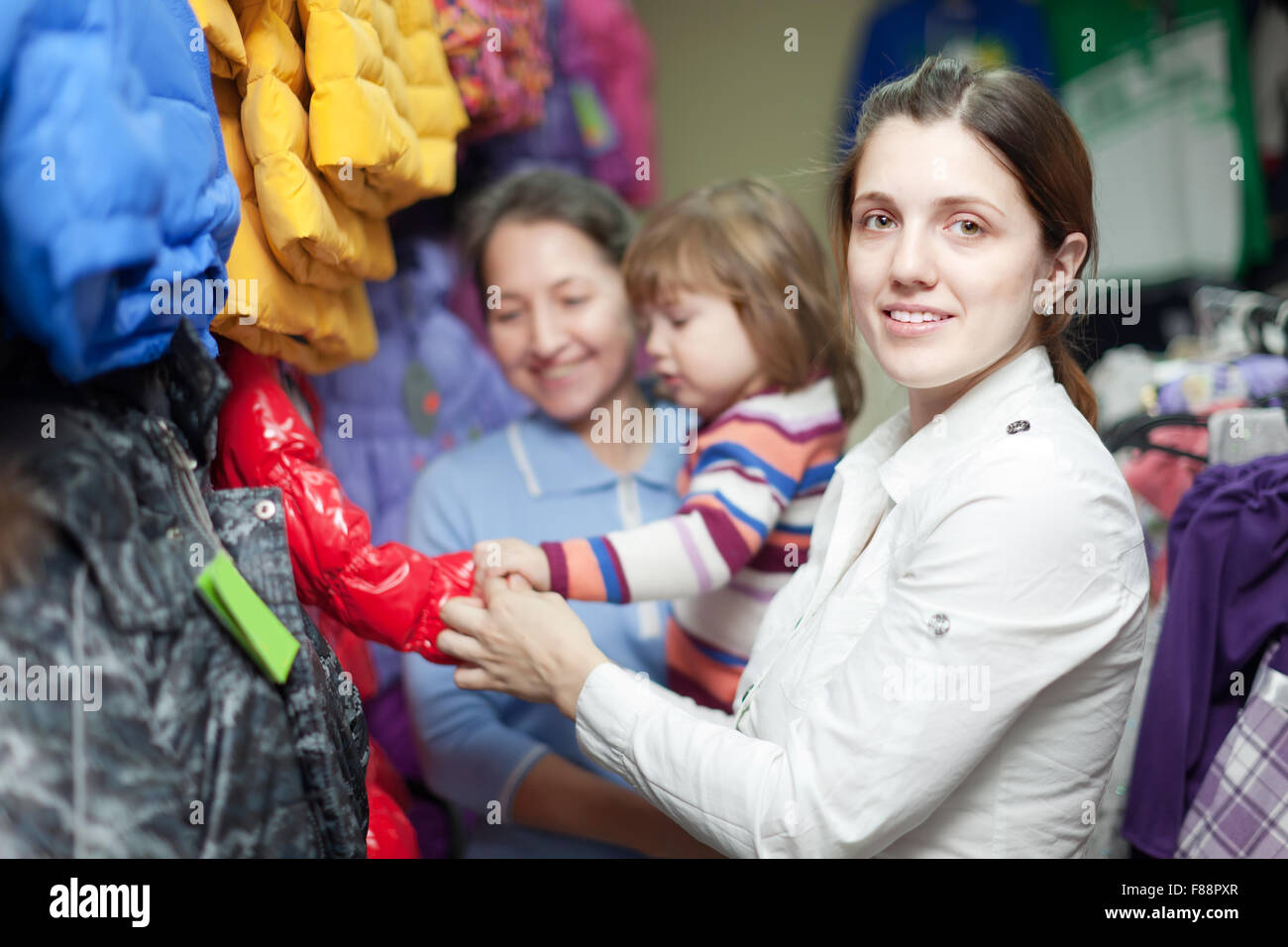 Happy family of three generations chooses wear at clothes store Stock ...