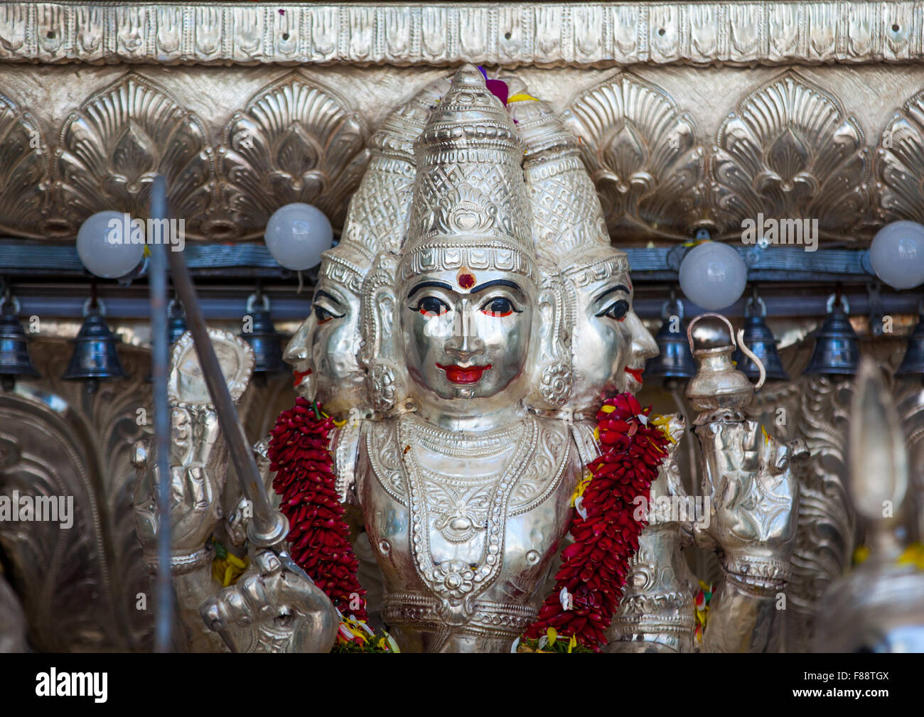 A Statue Of A Hindu Deity With Three Heads In Batu Caves, Southeast ...