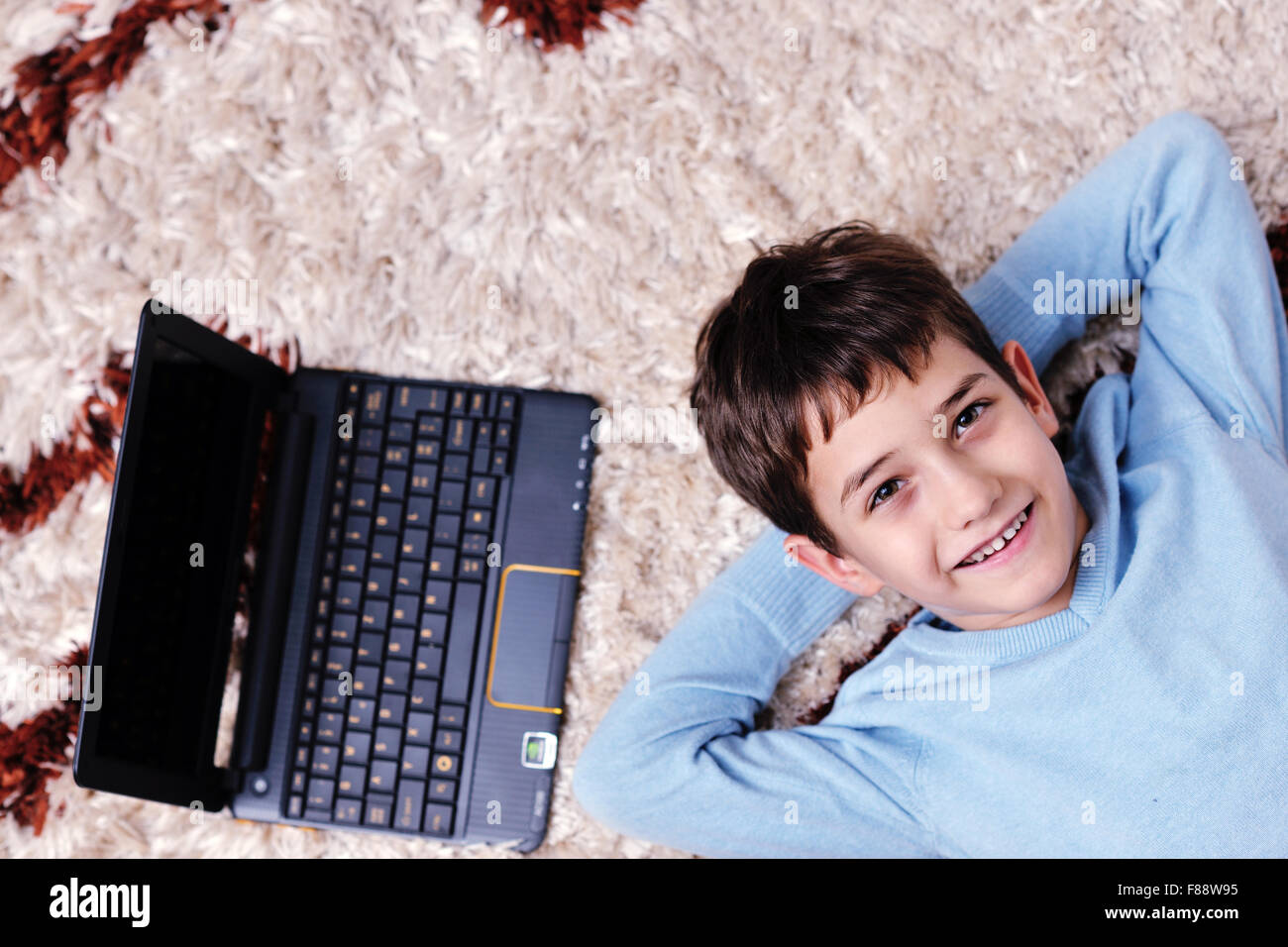 happy child boy relax at home with laptop computer in background Stock ...