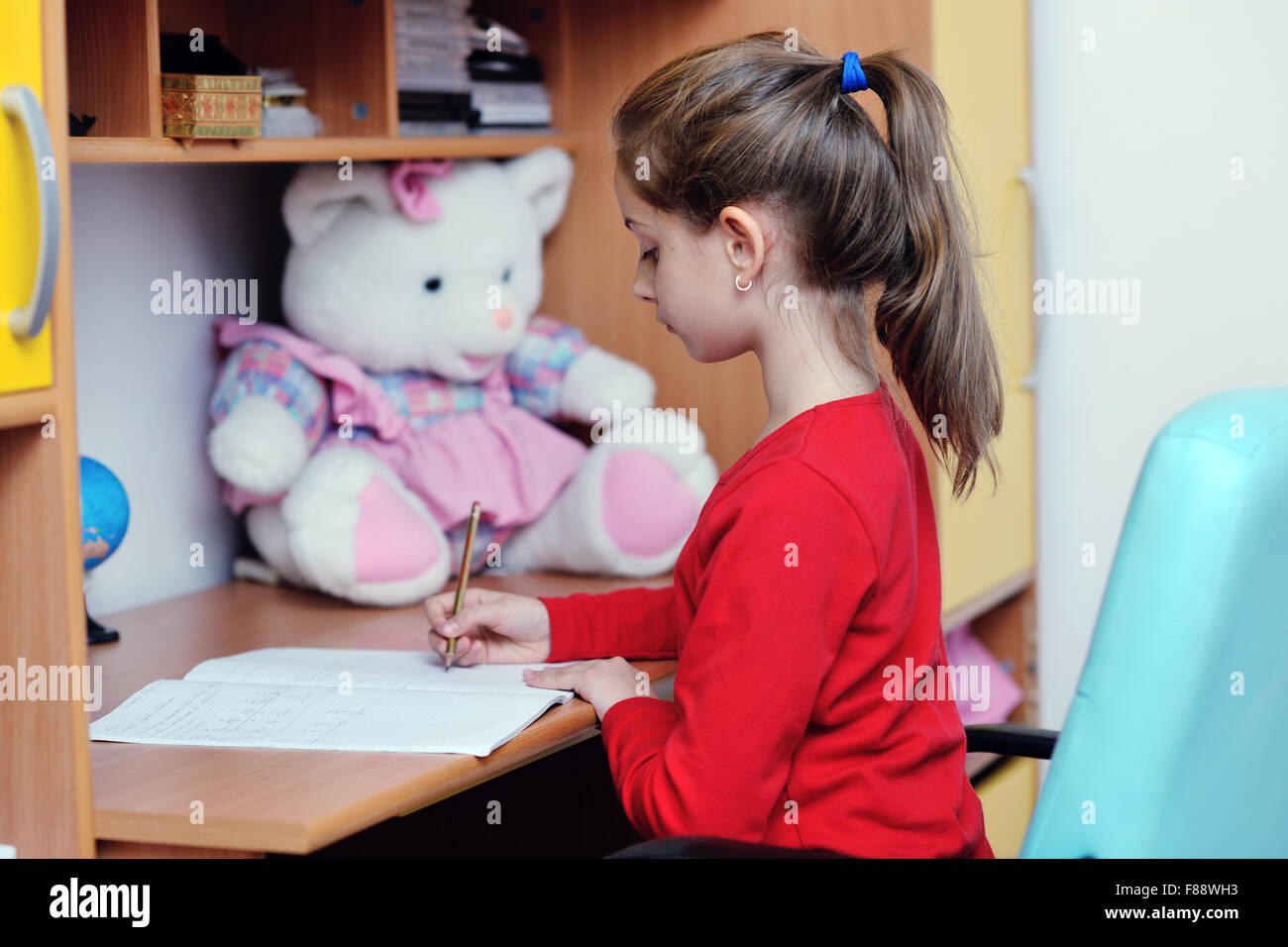 happy young school girl doing homework at home Stock Photo - Alamy