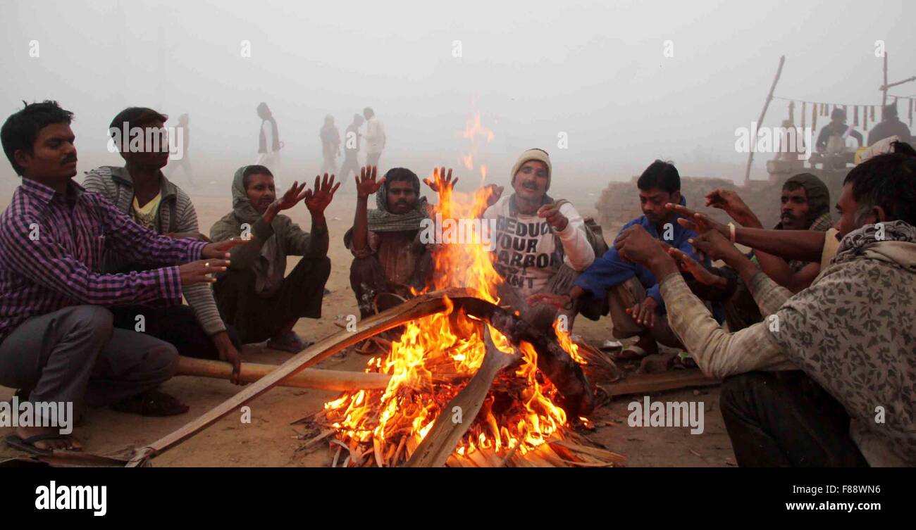 Allahabad, India. 07th Dec, 2015. Homeless people sitting around a bone ...