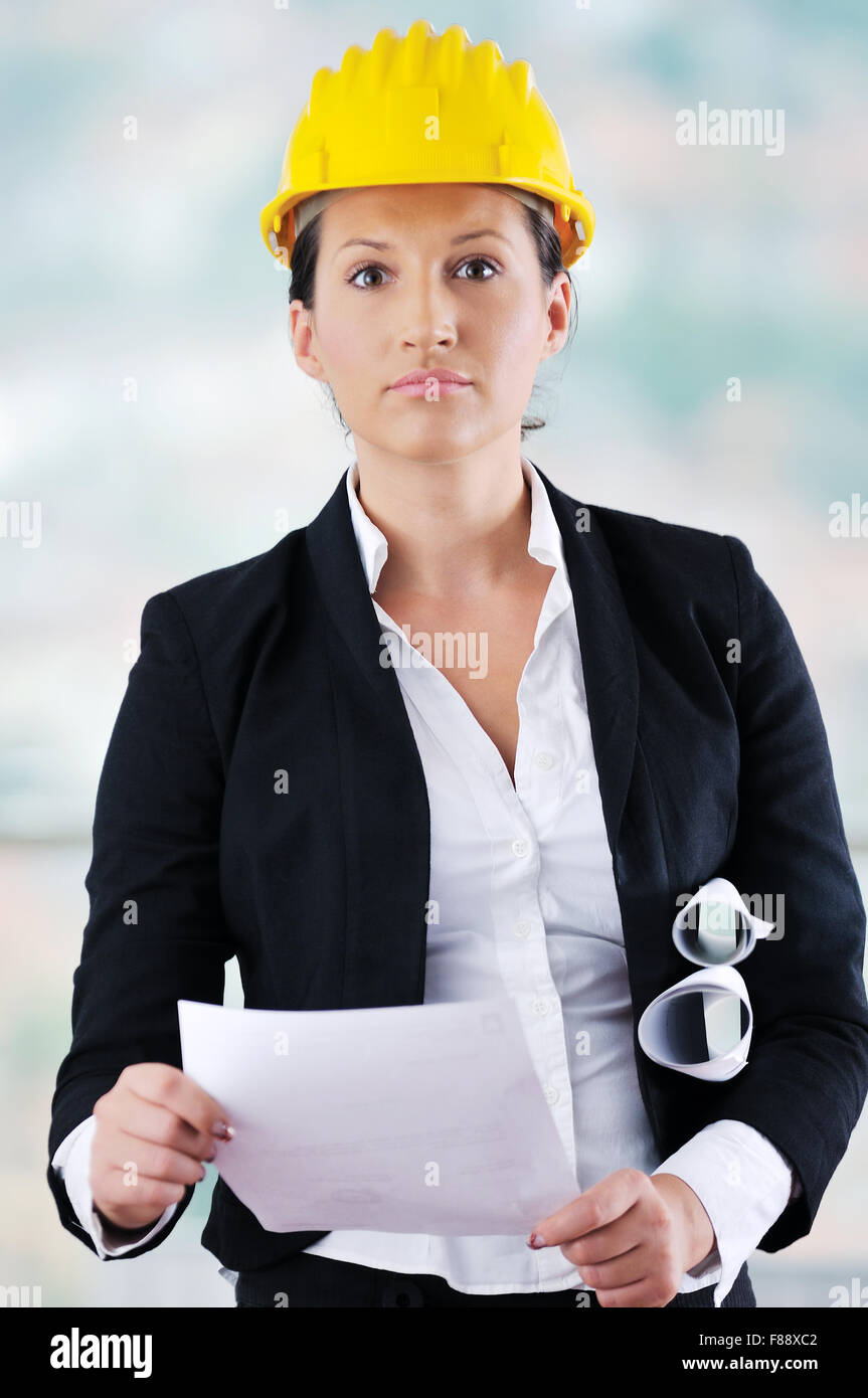 young architect woman in business suit portrait with yellow hemet and ...
