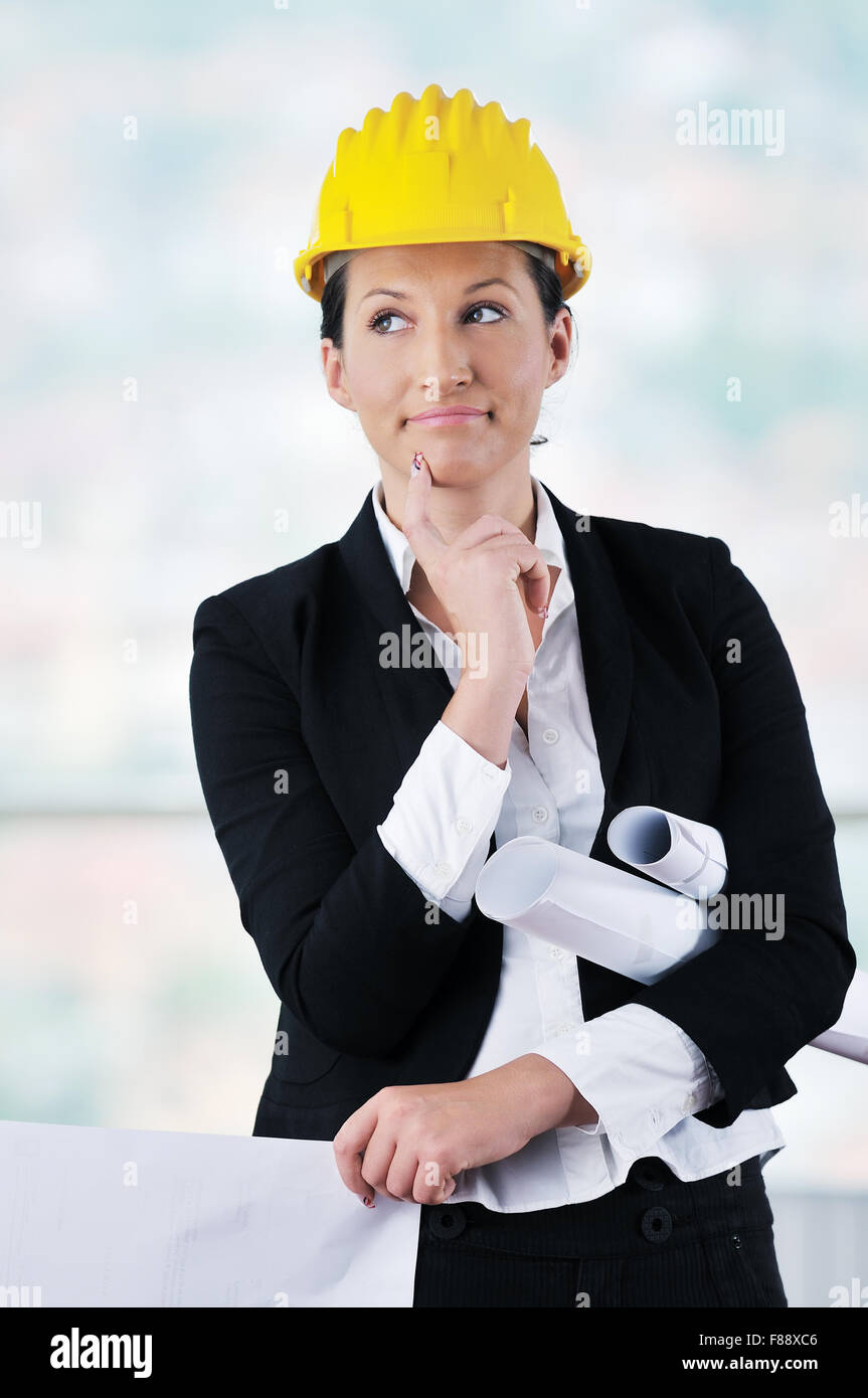 young architect woman in business suit portrait with yellow hemet and ...