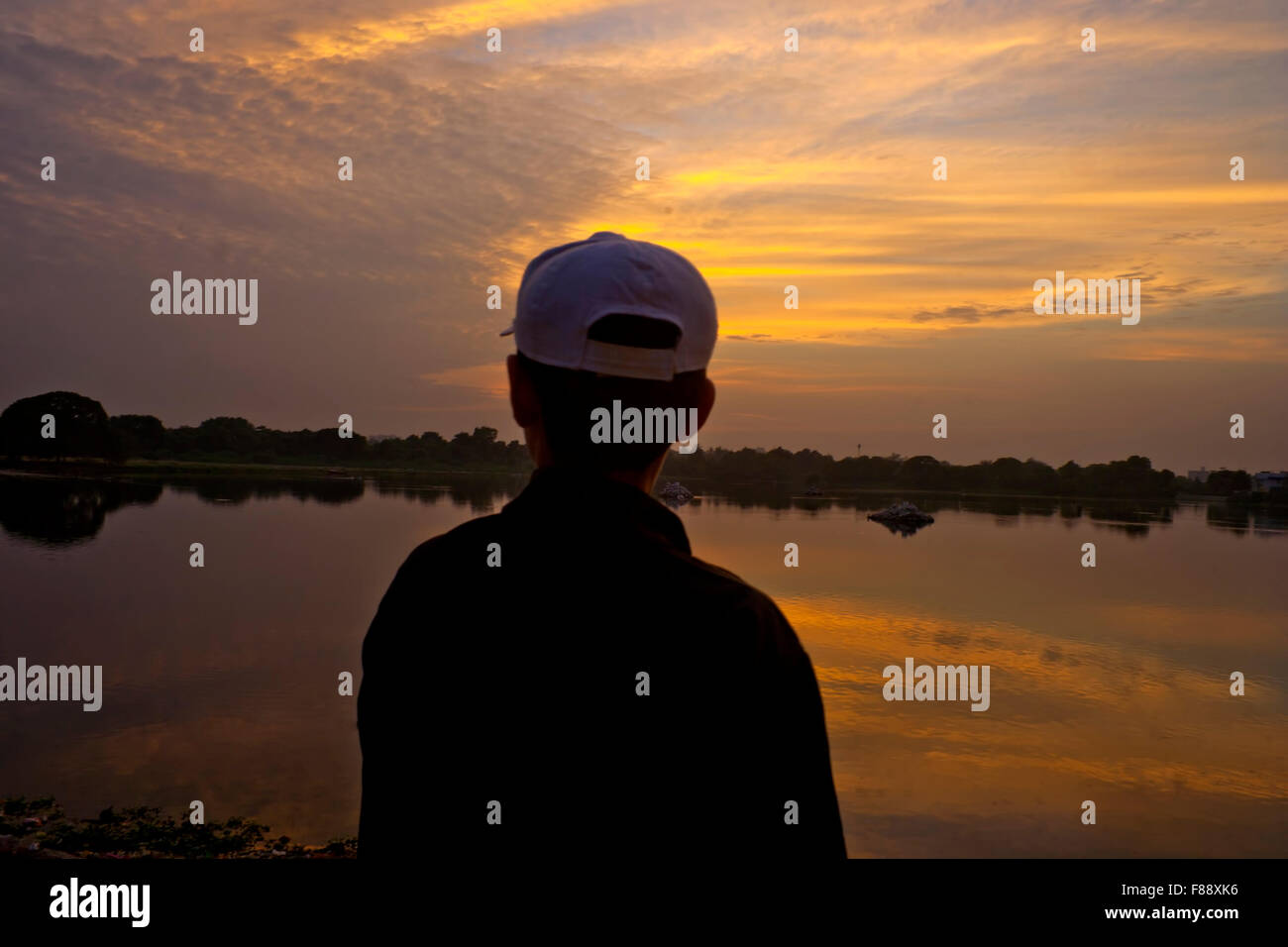 Caucasian kid at the time of sunset, wearing White cap Stock Photo - Alamy